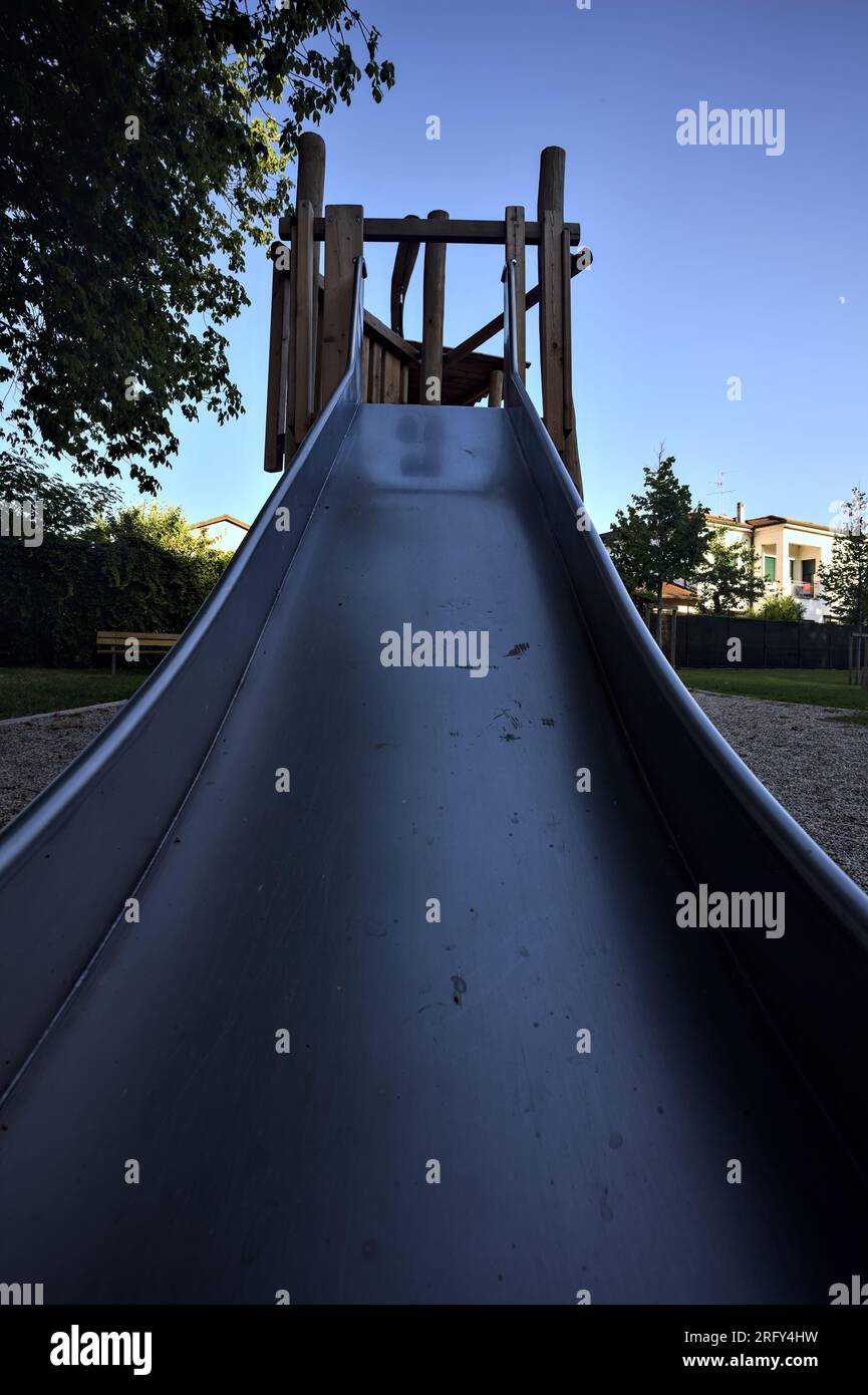 Slide in a playground seen from one end and up close Stock Photo - Alamy