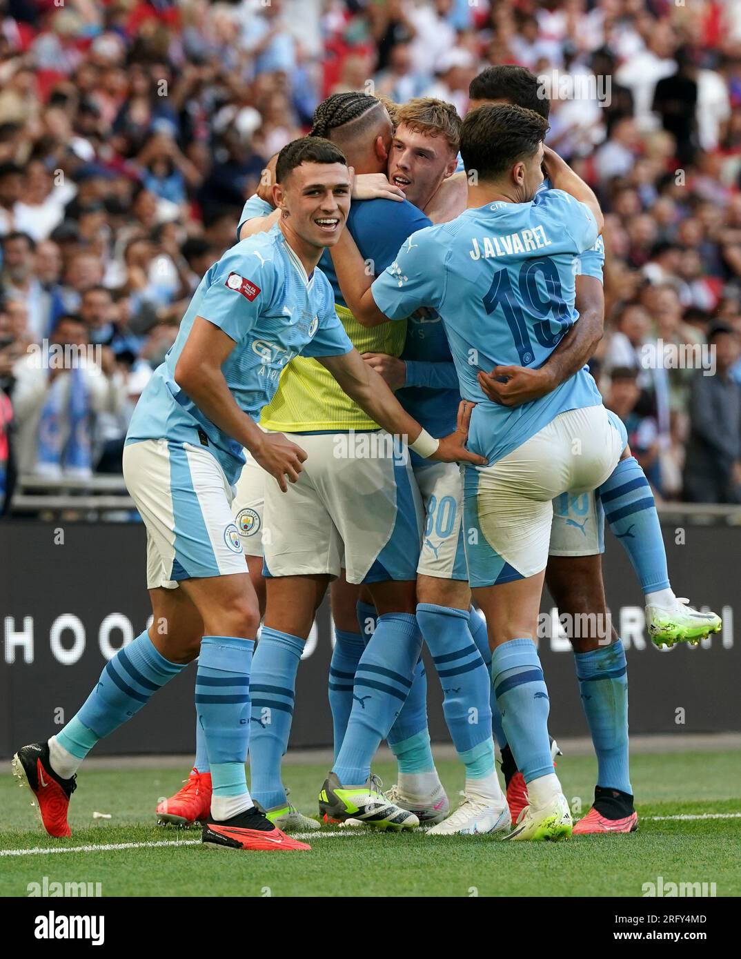 Manchester City's Cole Palmer (centre of huddle) celebrates with team ...