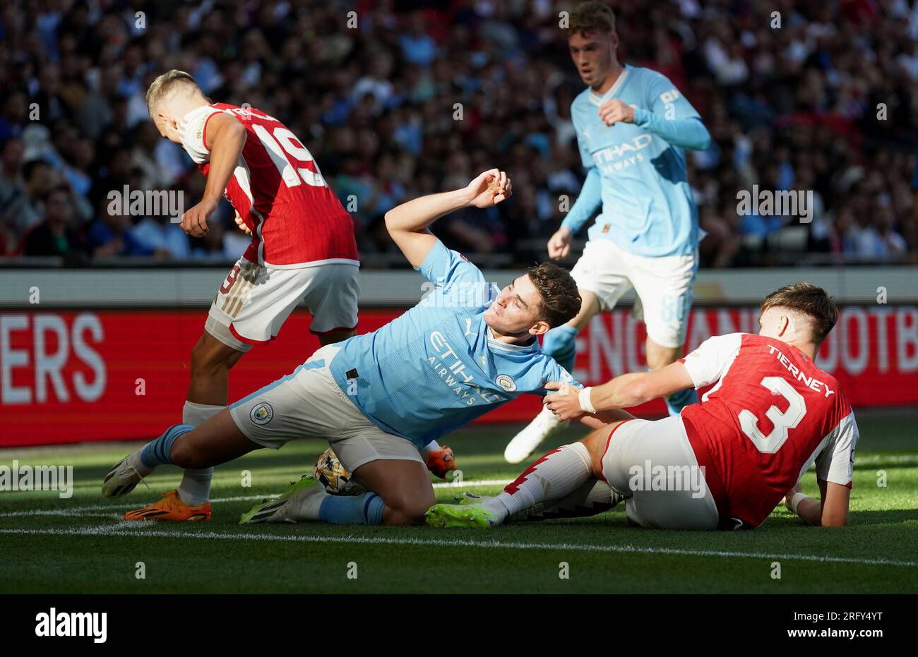 Manchester City's Julian Alvarez (centre) is stopped by Arsenal's ...