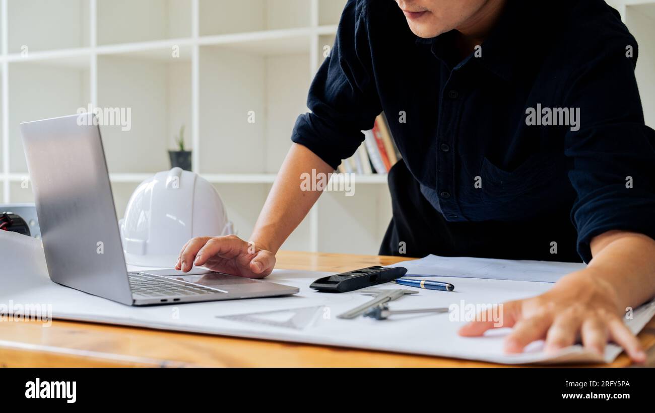 architects or engineers write a draft of the construction project on ...