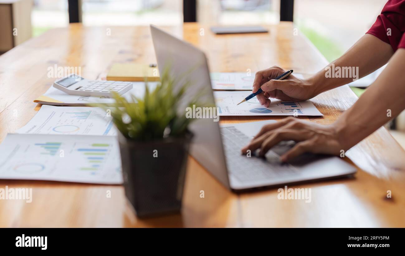 accountant with laptop and paperwork analyzing financial data report ...