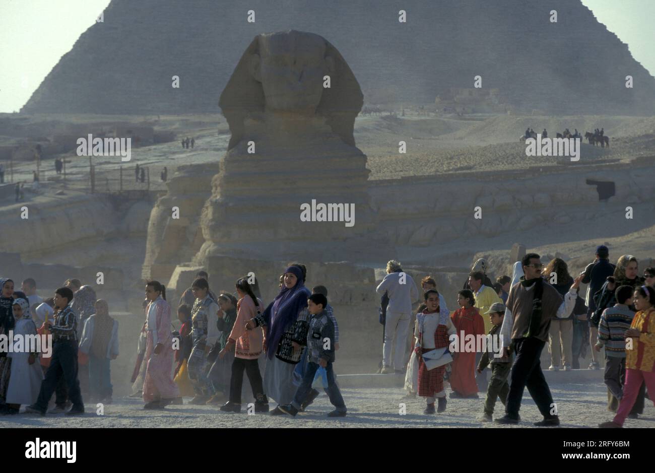 Tourists at the monument of Sphinx in front of pyramids of giza near ...