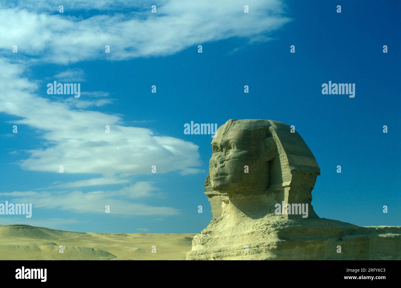 the monument of Sphinx in front of pyramids of giza near the city of ...