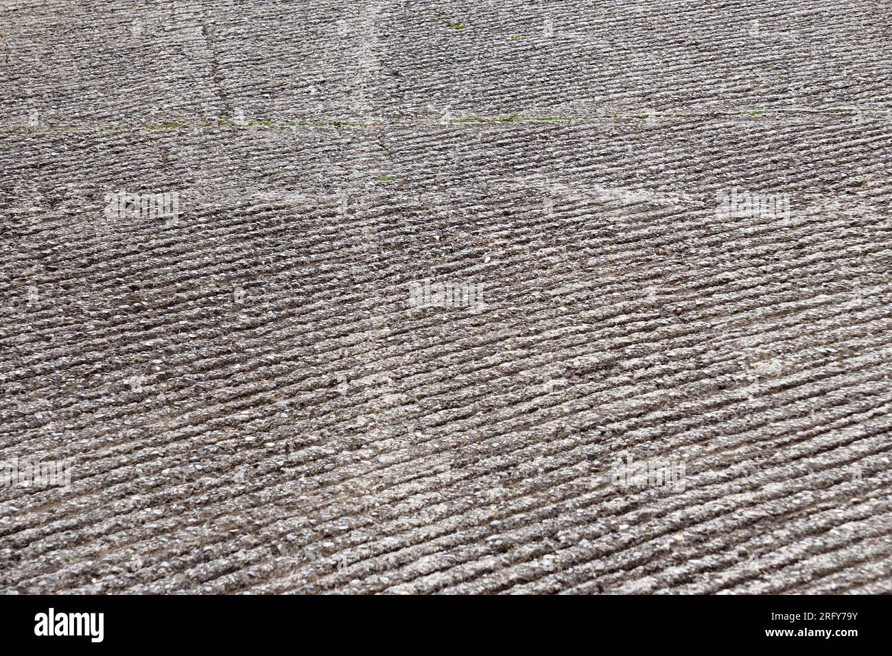 Anti slip perforated asphalt road surface. Textured rough roadway to ...