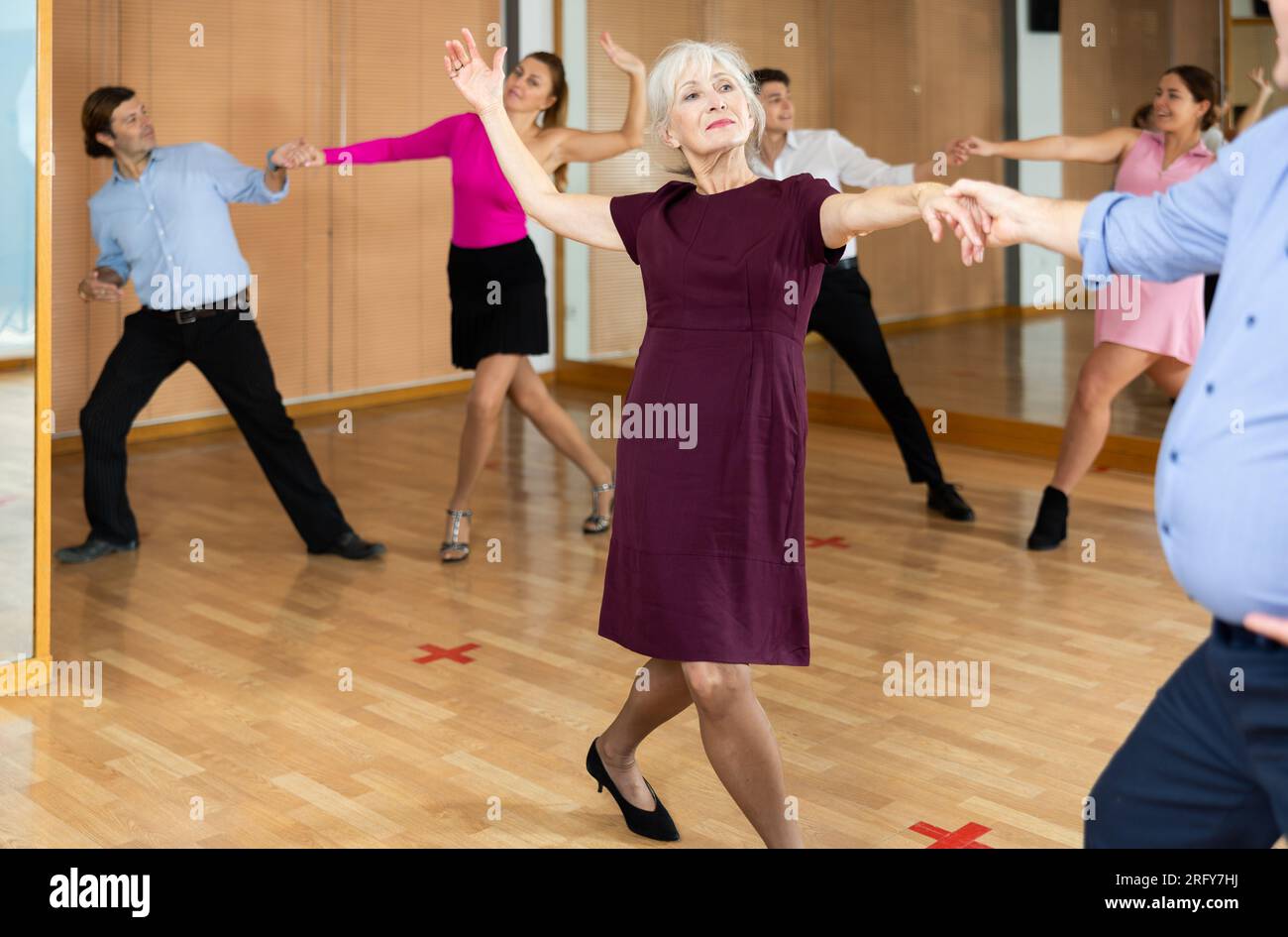 Elderly woman dancing playful balboa with partner in studio Stock Photo ...
