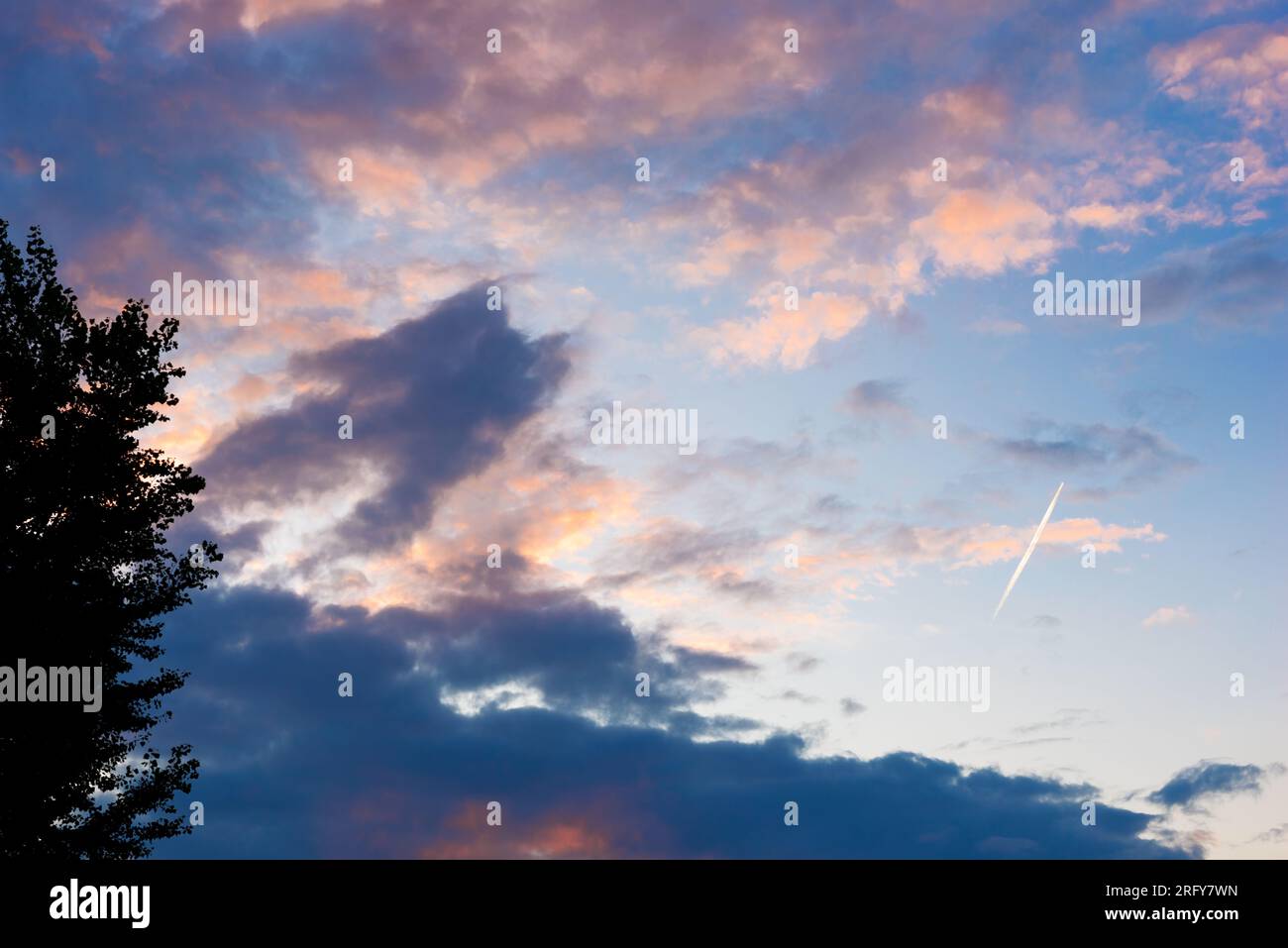 Dark gray and white with ornage shade patchy stratocumulus clouds ...