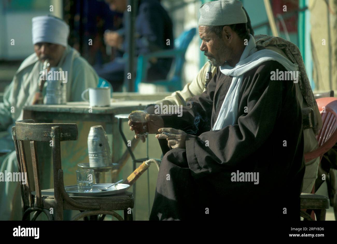men at a traditional Coffee shop at the main Bazaar or Market in the city of Cairo in Egypt in ...