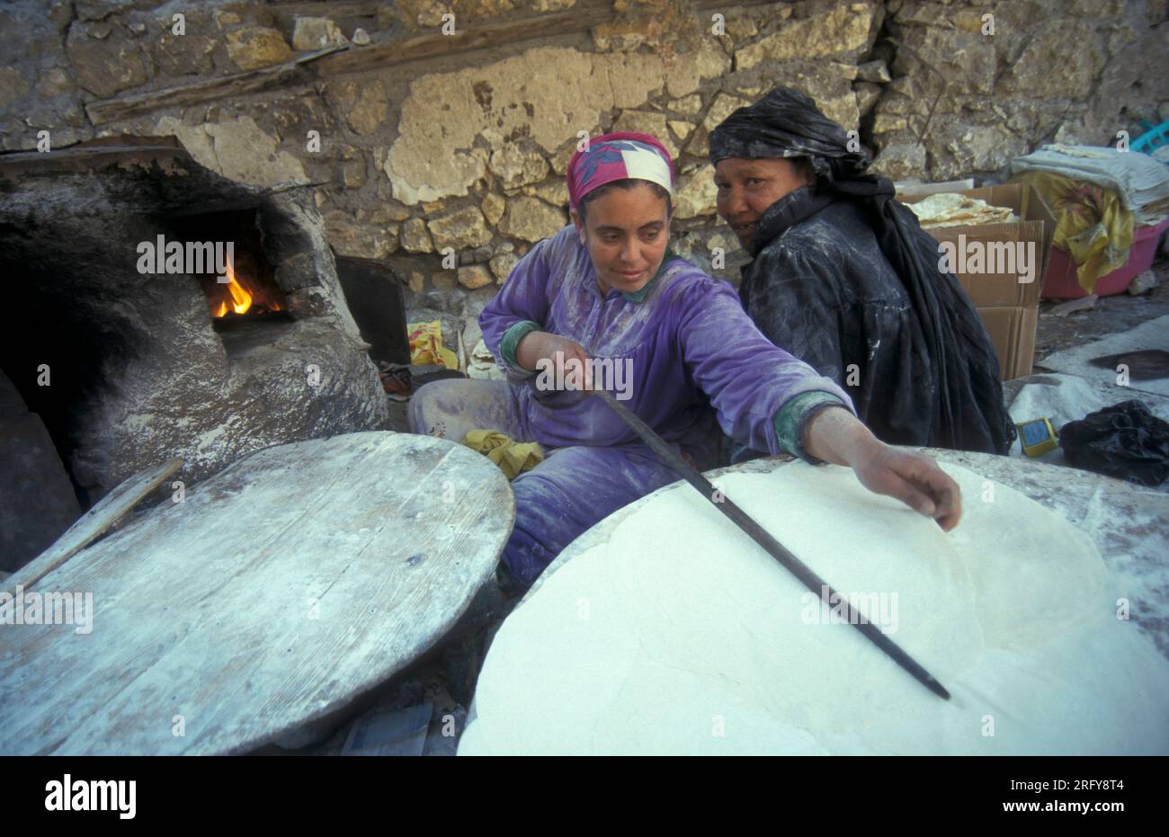 a women bake a Bread in the Town and Oasis of Farafra in the Libyan or ...