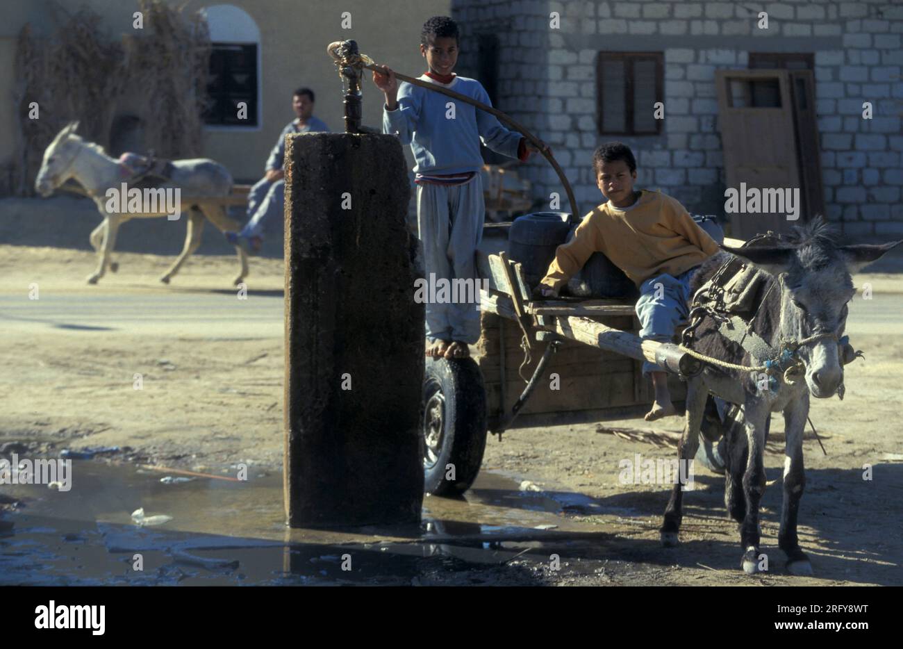 children take water from a deep well or spring in the Town and Oasis of ...