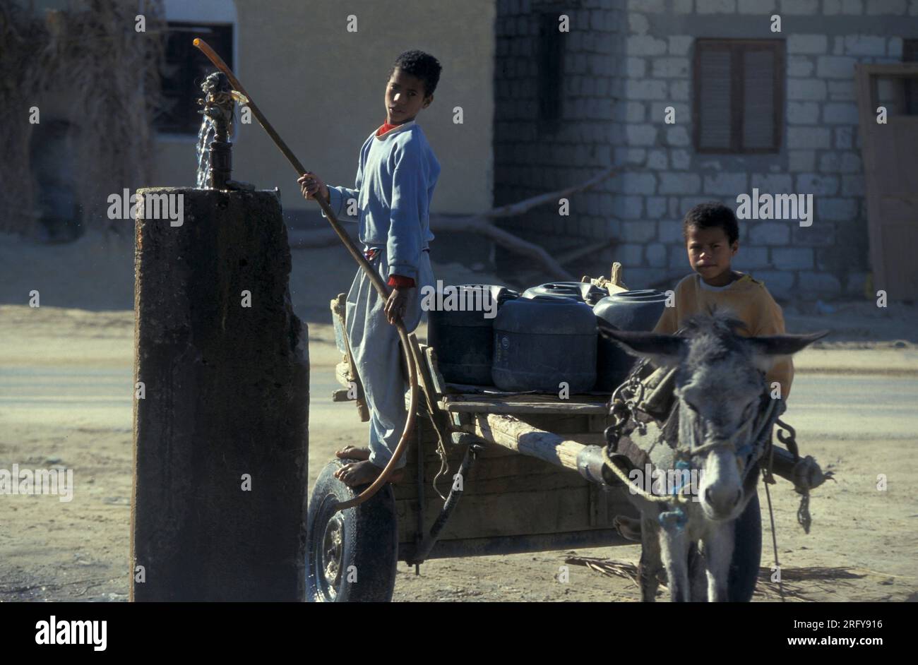 children take water from a deep well or spring in the Town and Oasis of ...