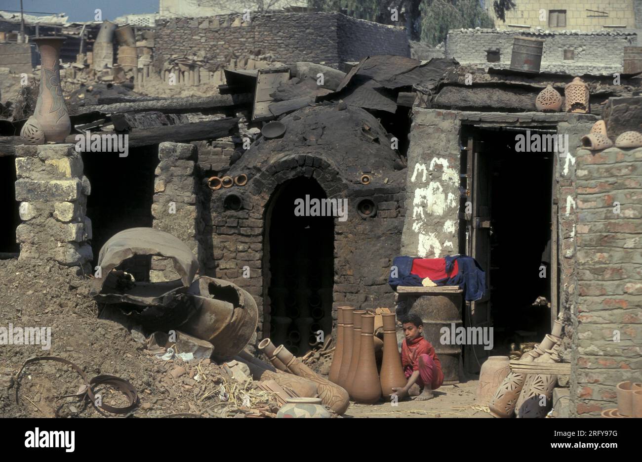 a child is working in a Pottery Factory in the Old Town of Cairo the ...