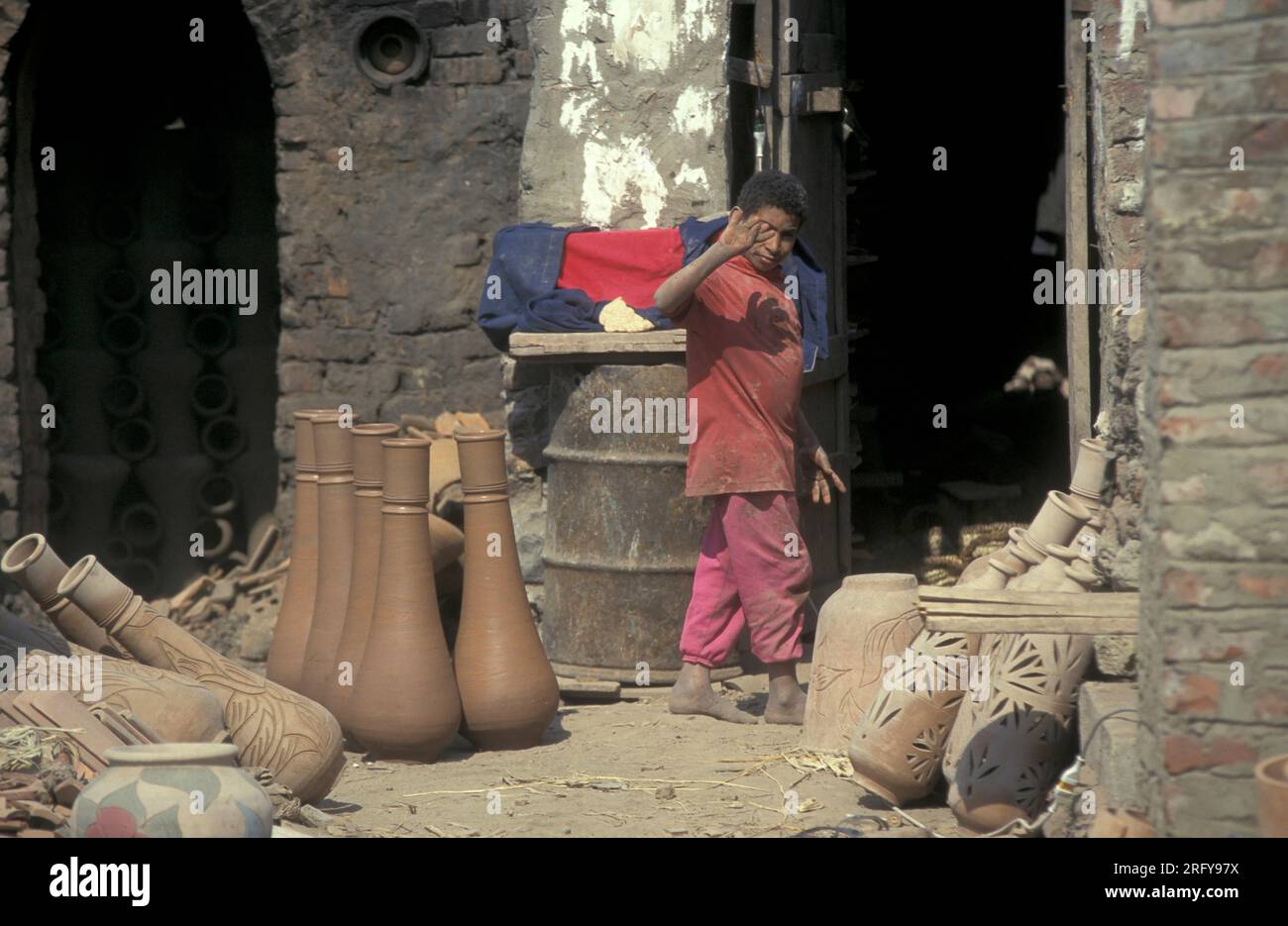 a child is working in a Pottery Factory in the Old Town of Cairo the ...