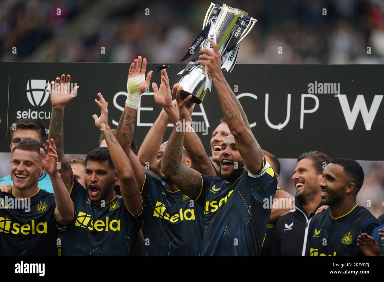 Newcastle United’s Jamaal Lascelles lifts the trophy after the Sela Cup ...