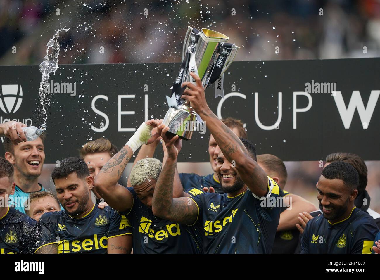 Newcastle United’s Jamaal Lascelles lifts the trophy after the Sela Cup ...