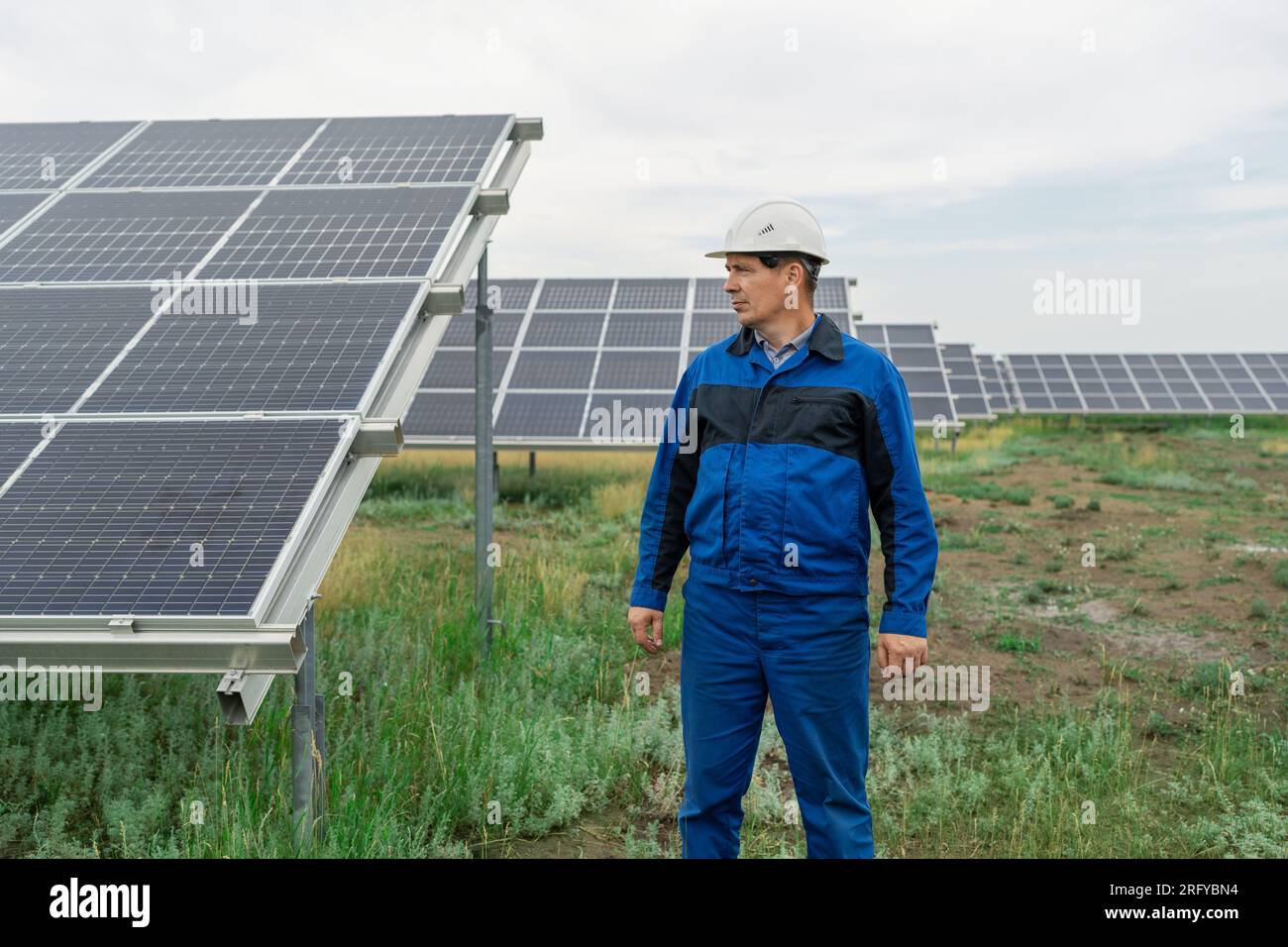 Service Engineer man standing in front of solar panels. Technician ...