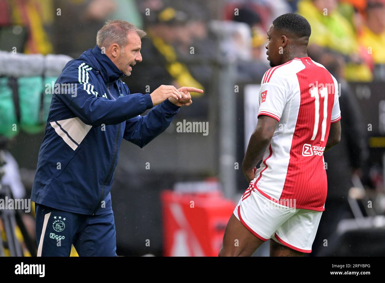 DORTMUND - (lr) Ajax coach Maurice Steijn gives instructions to Steven Bergwijn of Ajax during ...