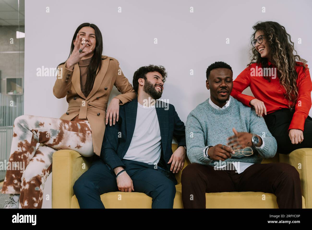 Having fun at work. Four multiracial group of people having fun at work ...