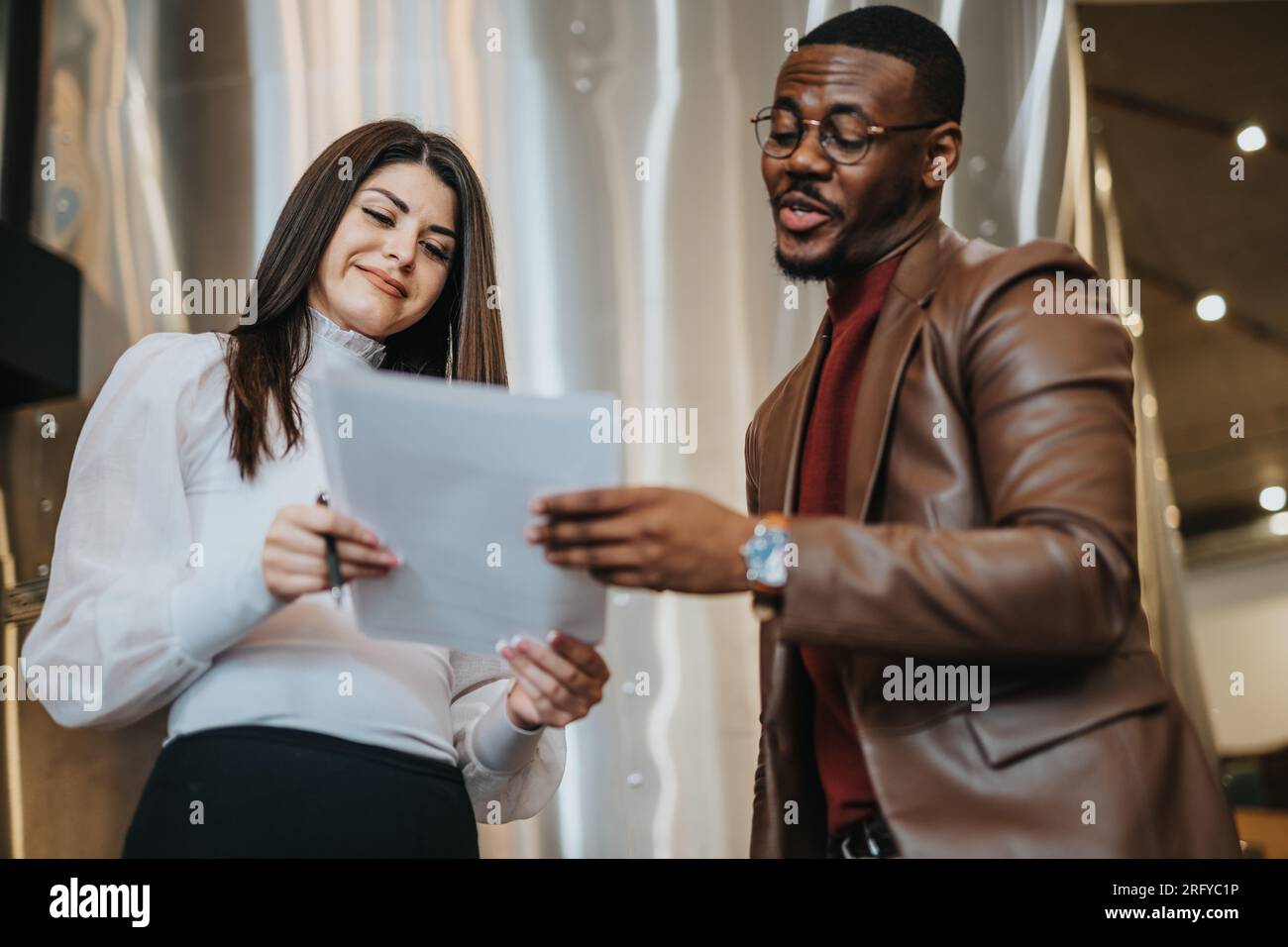 Two business people going through the paperwork to find the necessary ...