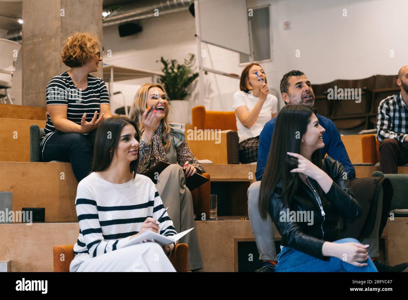 Inter-generational group of people started laughing and talking back to ...