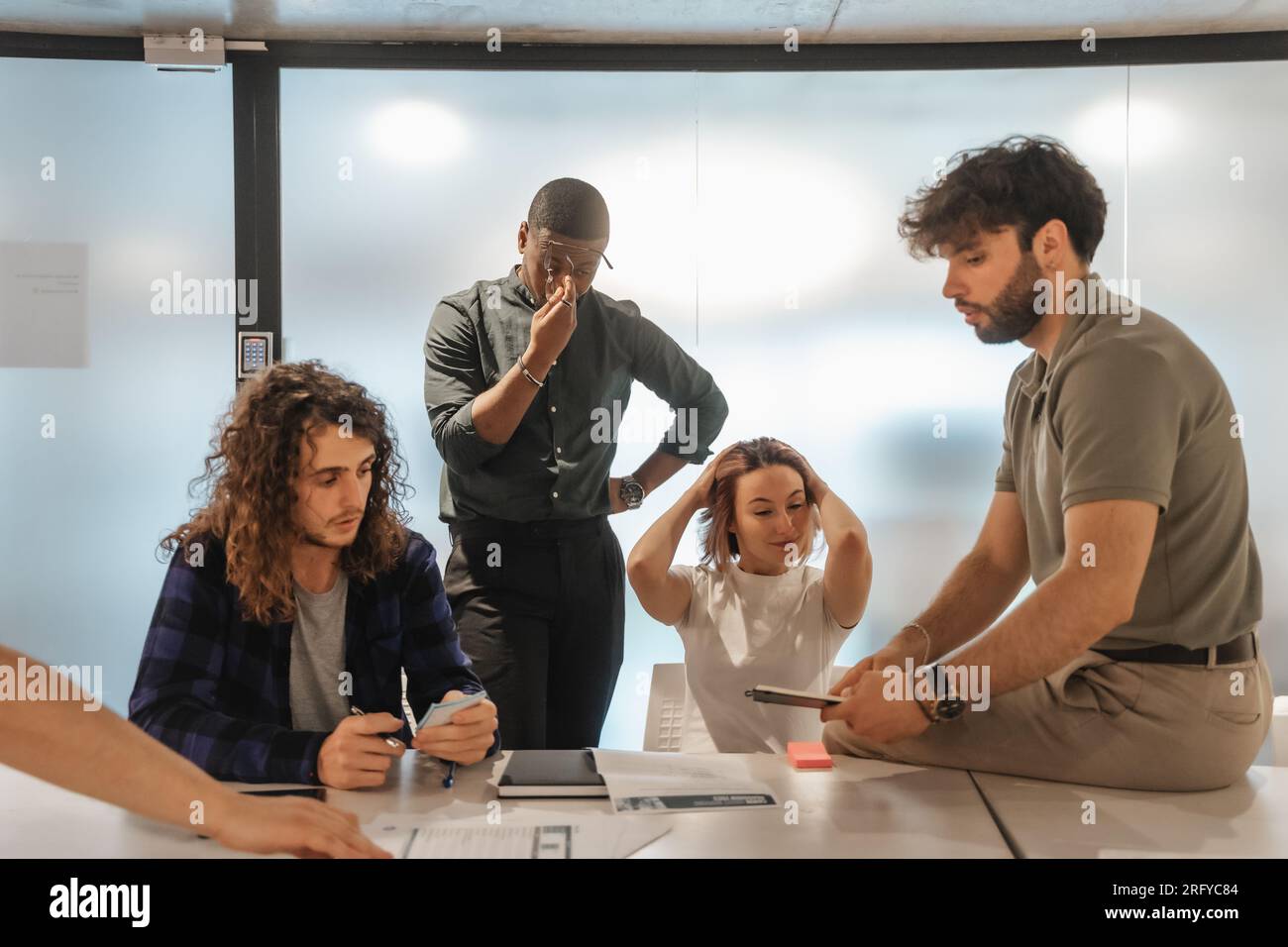 Four multiracial colleagues are solving a mistake at the project all ...