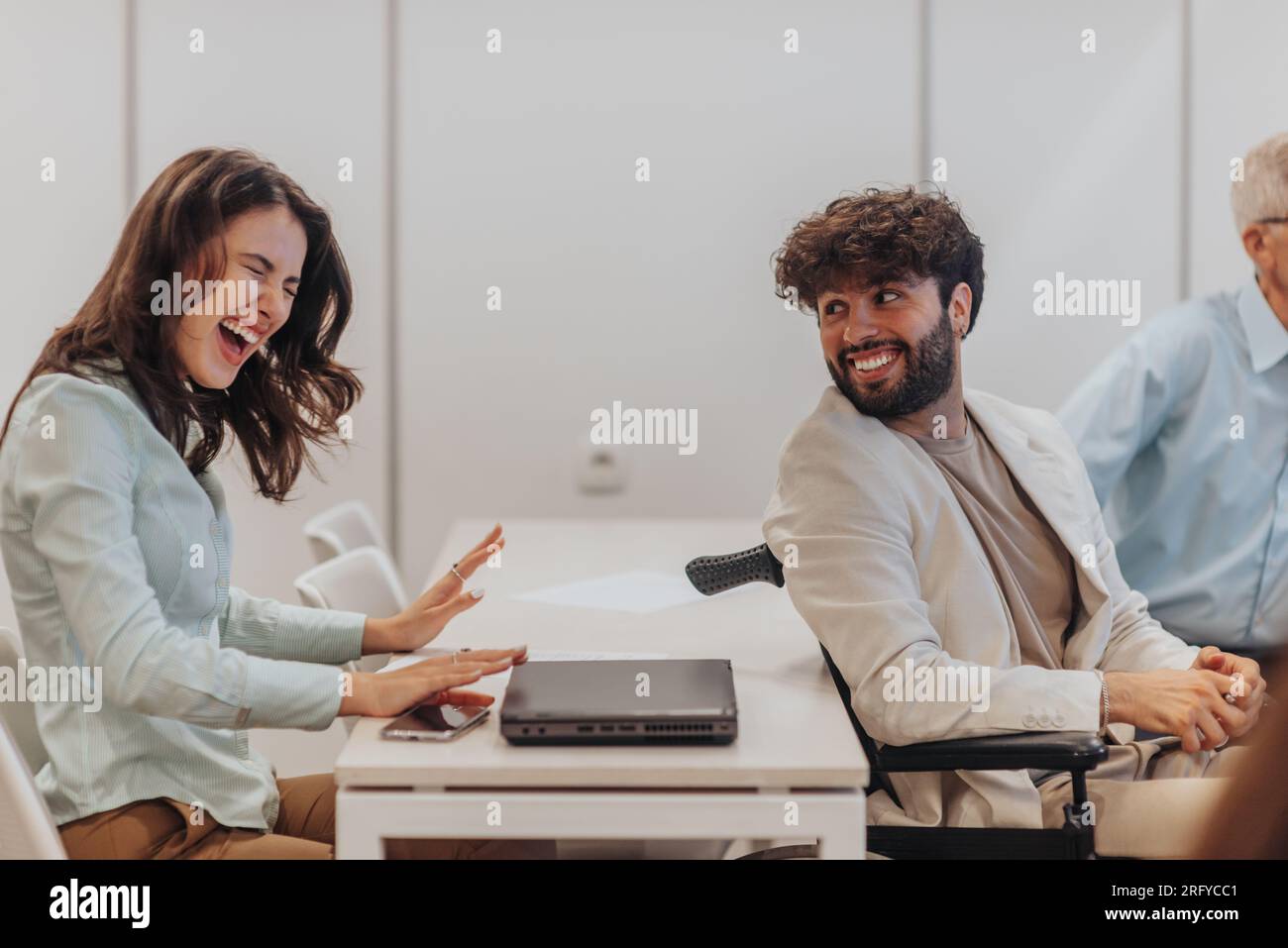 Brunette woman reacting to good news at work that her disabled male ...