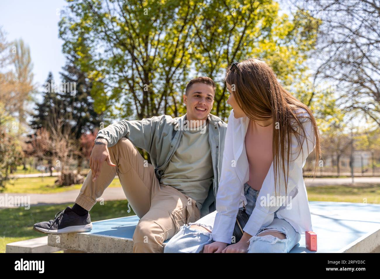 Funny couple laughing with a white perfect smile and looking each other ...