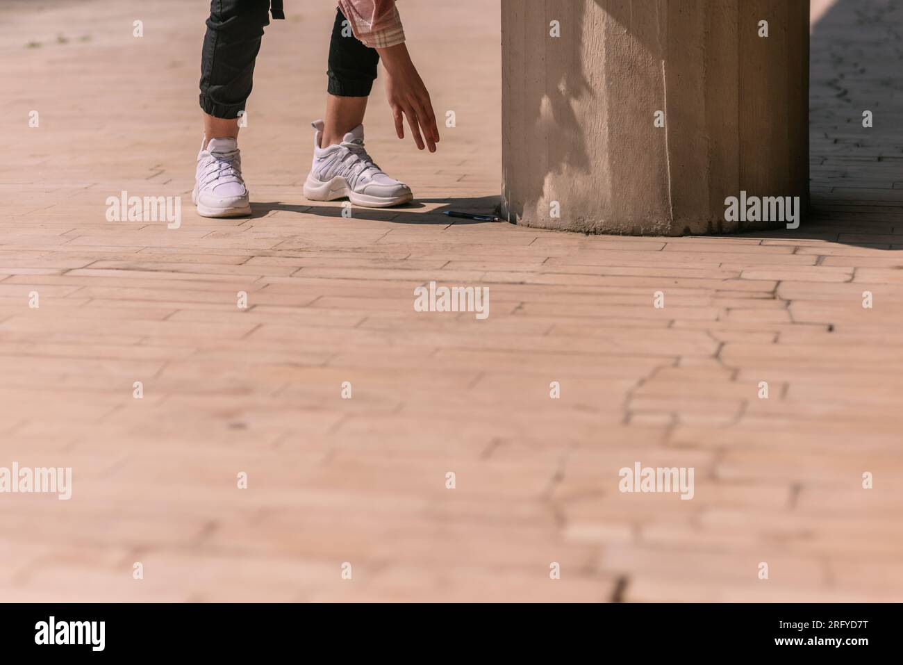 Girl taking a pen that fell down Stock Photo - Alamy