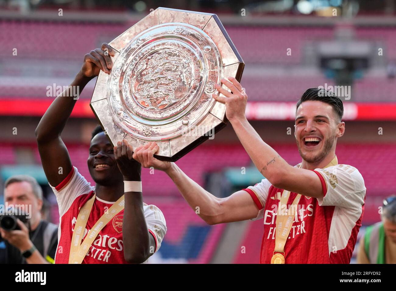 Arsenal's Declan Rice, right, and Arsenal's Bukayo Saka hold the trophy ...