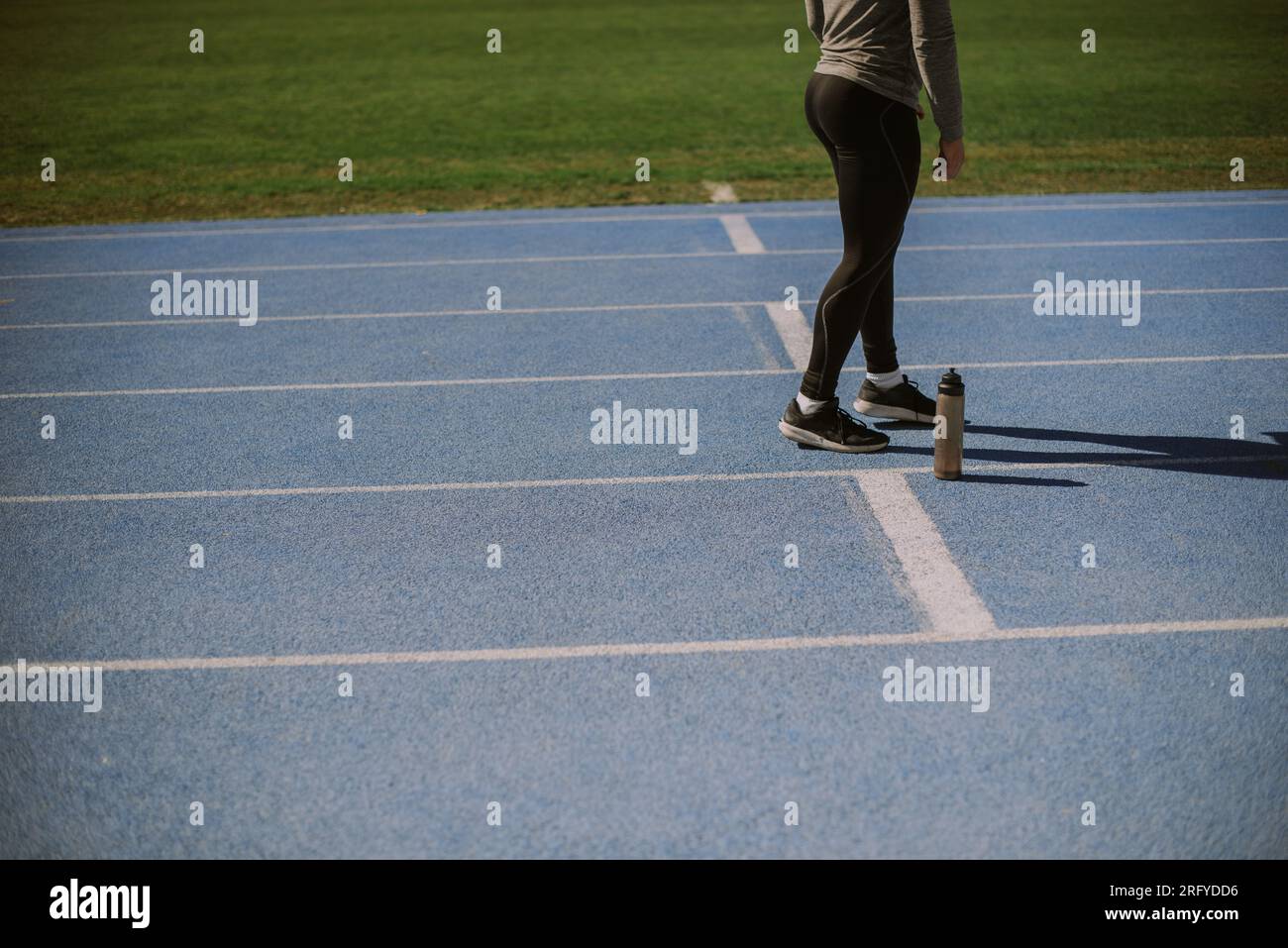 A male runner is about to jog around the stadium. He is getting ready ...