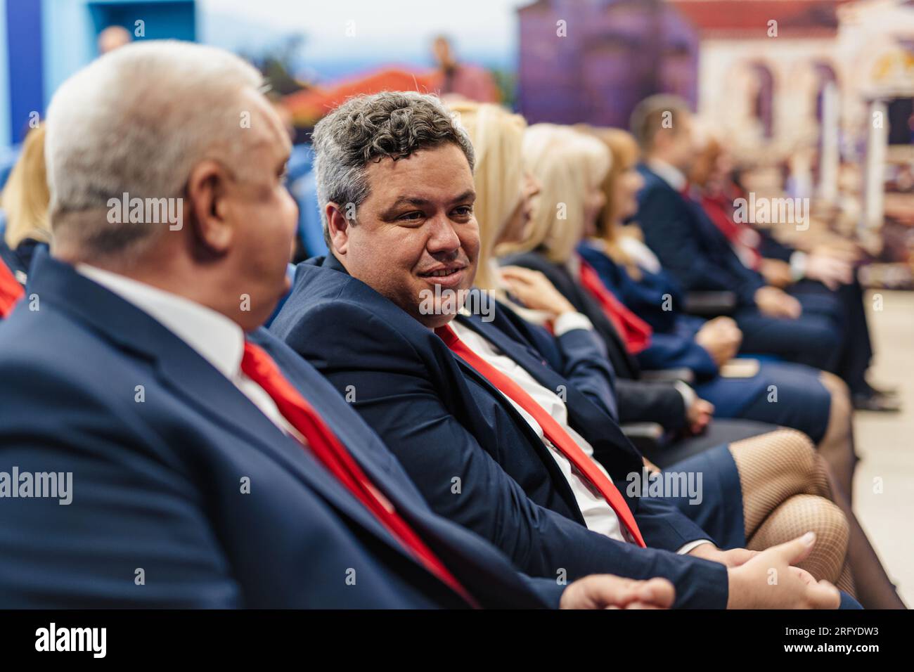 Mature and middle aged professor talking to his work colleague at the ...