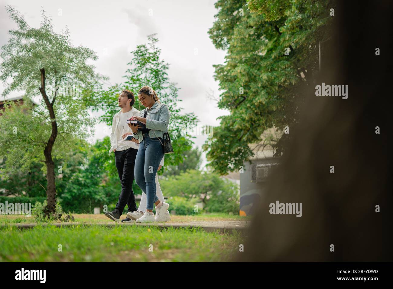 Group of teenage high school students standing outside, talking and ...