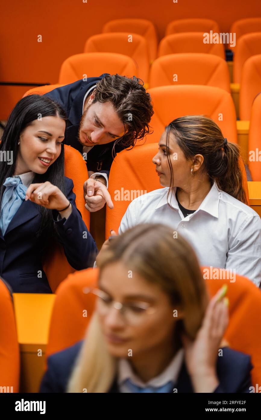 Three students talking and not paying attention in class Stock Photo ... Three students talking and not paying attention in class Stock Photo ...