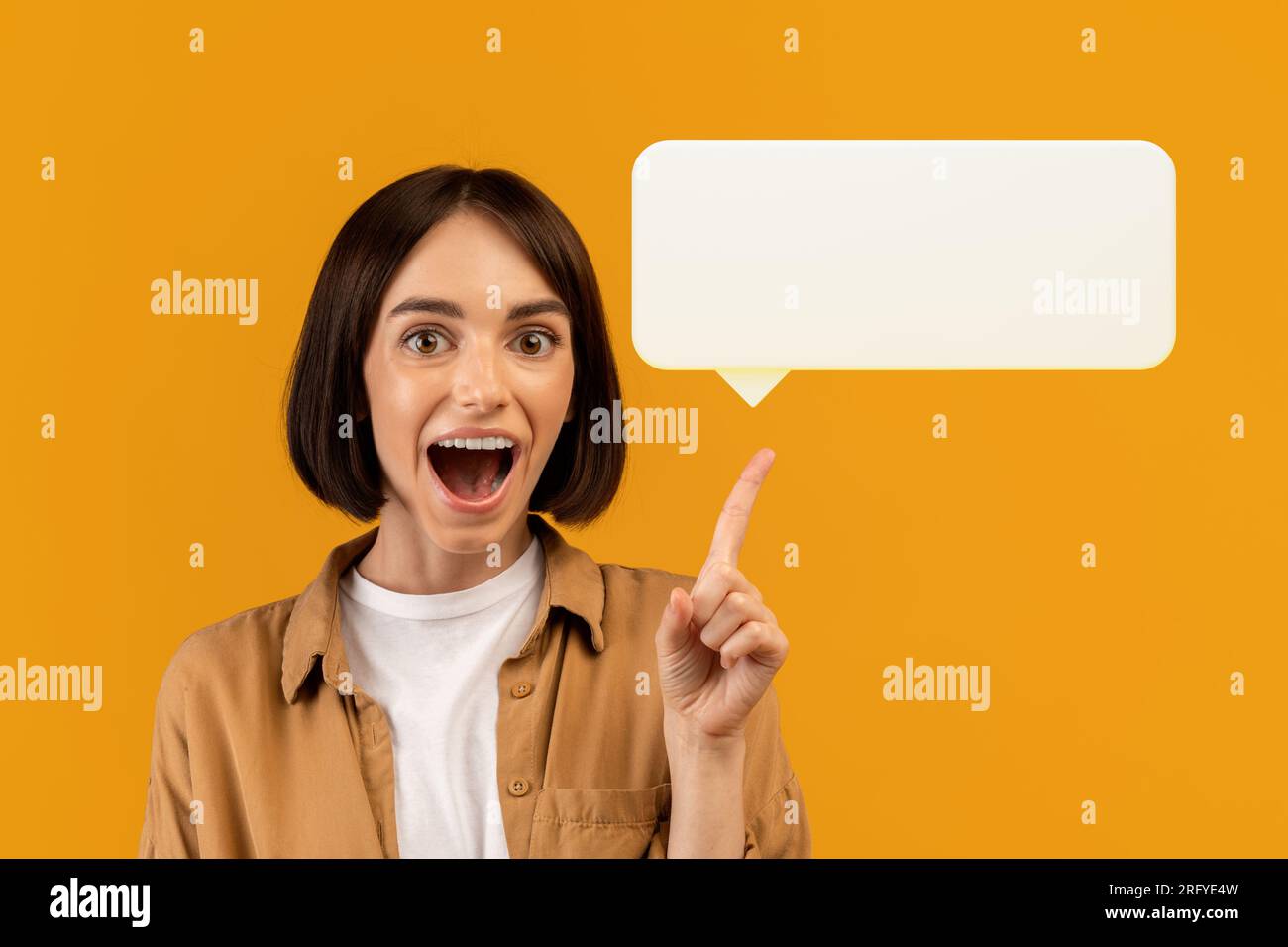 Emotional young woman having great idea, pointing at communication ...