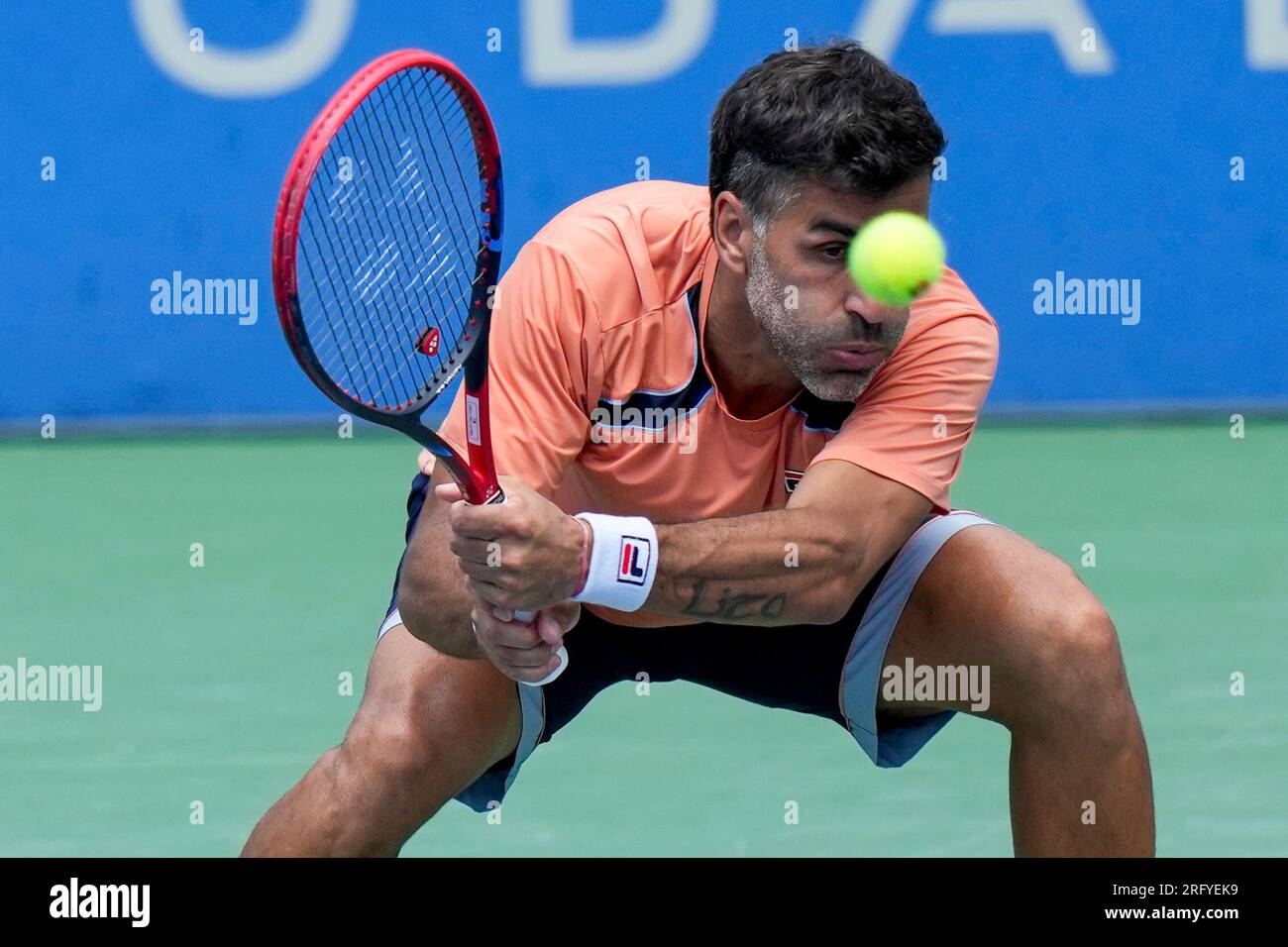 Maximo Gonzalez, of Argentina, hits the ball back against Mackenzie ...