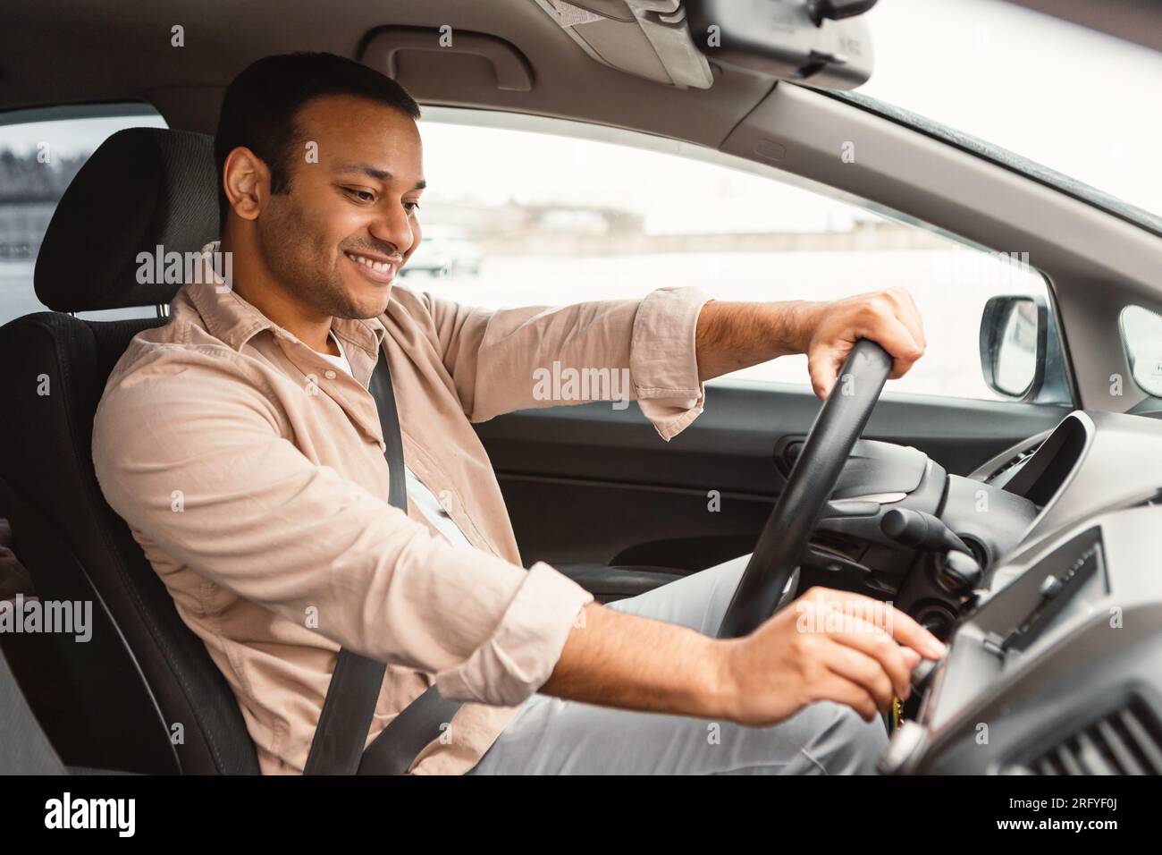 Middle Eastern Driver Man Pushing Buttons On Pannel Driving Auto Stock ...
