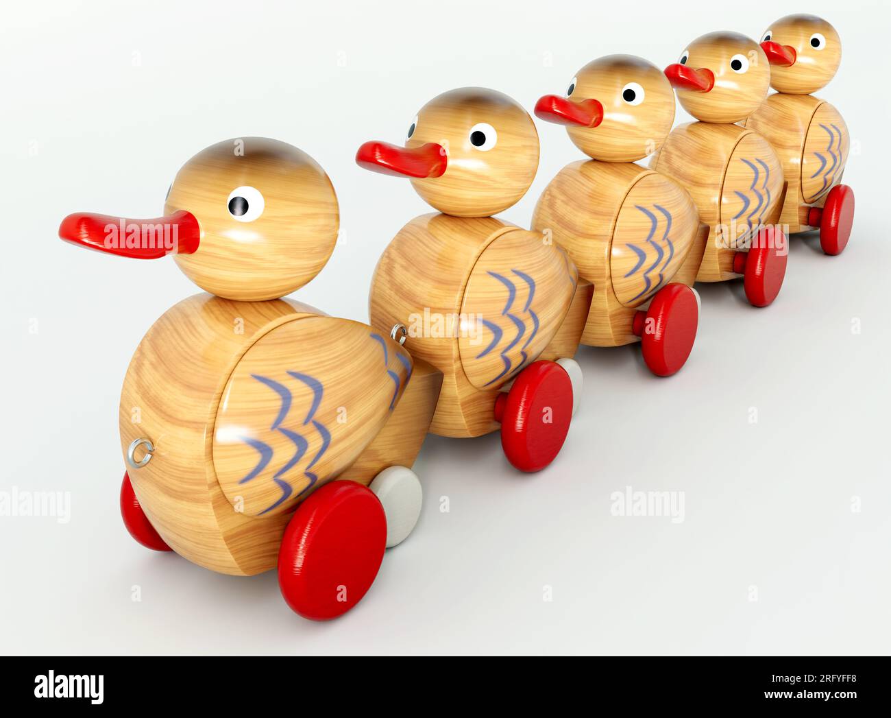 A row of organised wheeled wooden toy ducks with painted markings on an ...