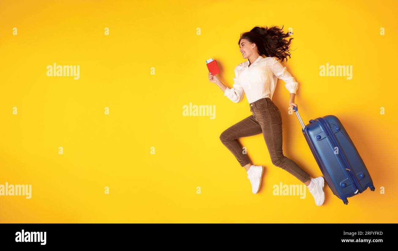 Happy Traveler Young Lady Running With Suticase On Yellow Background ...