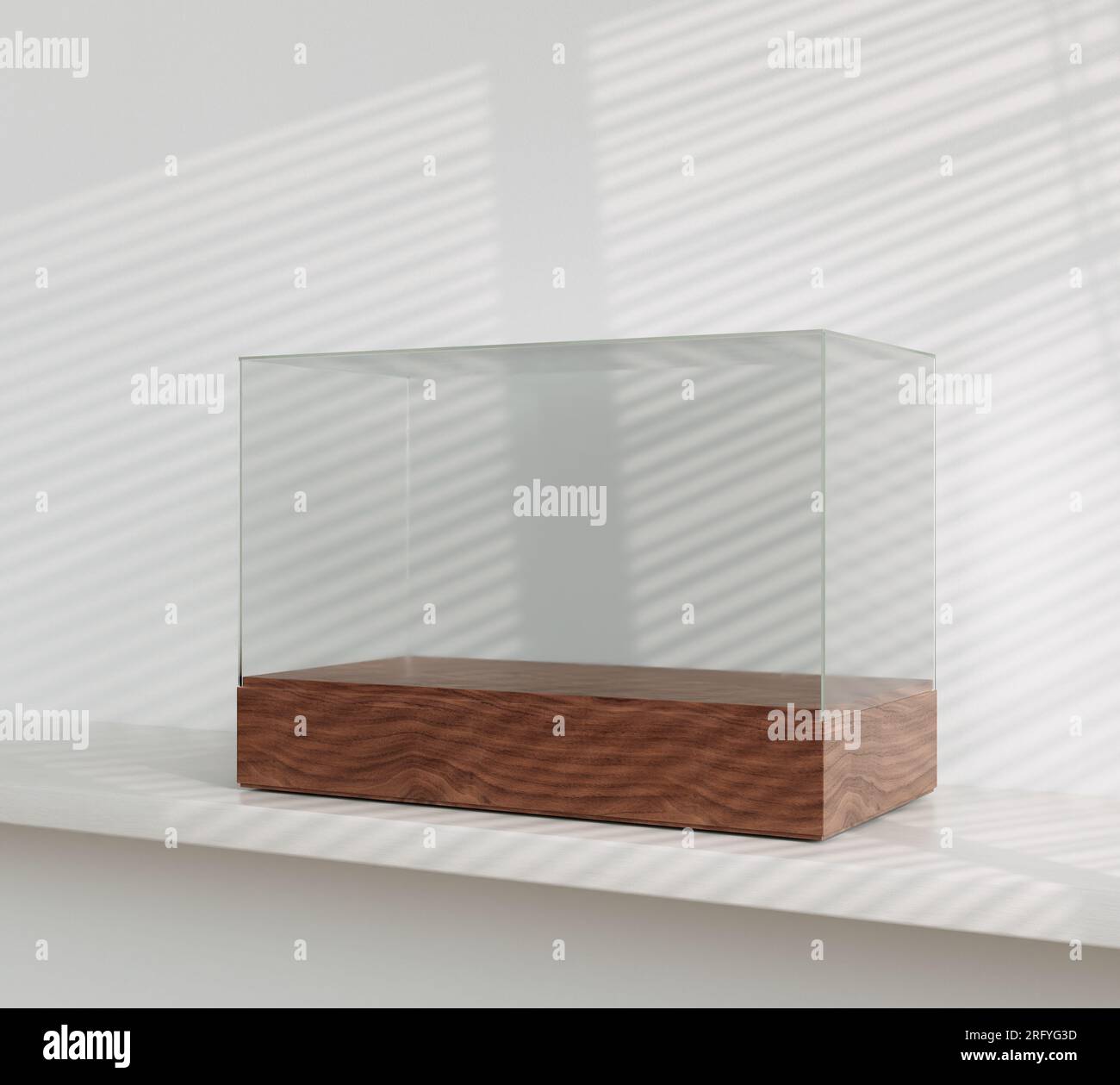 An empty glass display case with a wooden base sitting on a white shelf ...