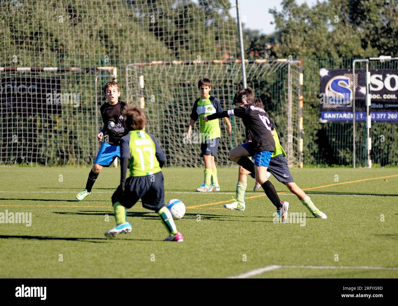 Young kids children teenage boys playing football soccer game sports in ...