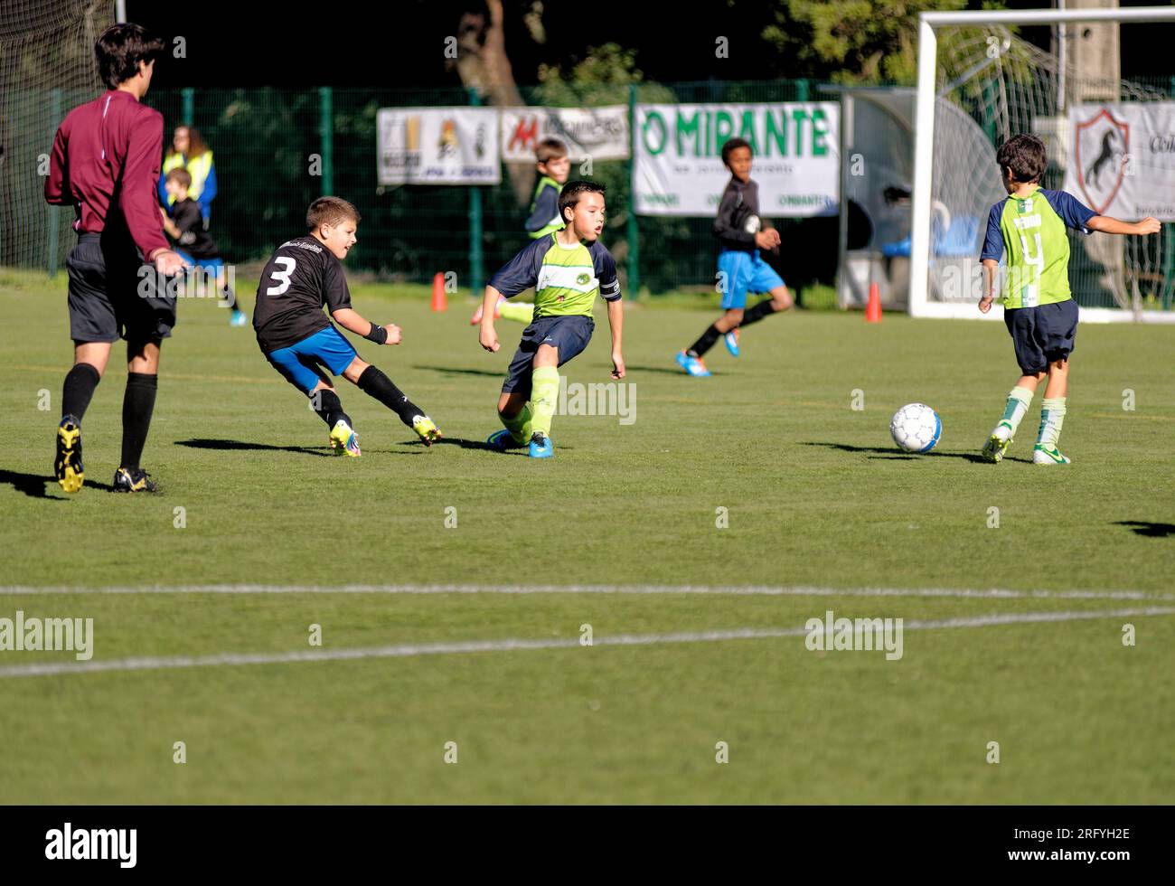 Young kids children teenage boys playing football soccer game sports in ...