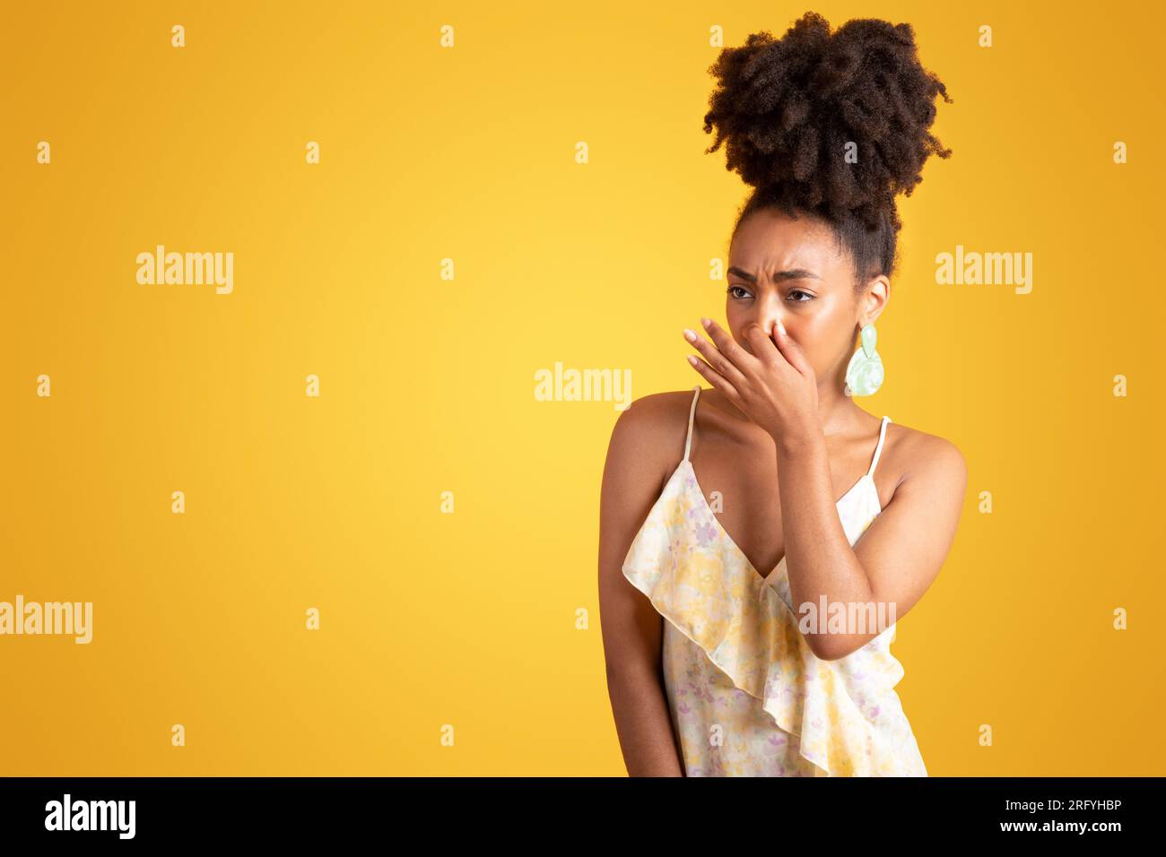 Sad millennial black lady in dress covers nose with hand, feels bad ...
