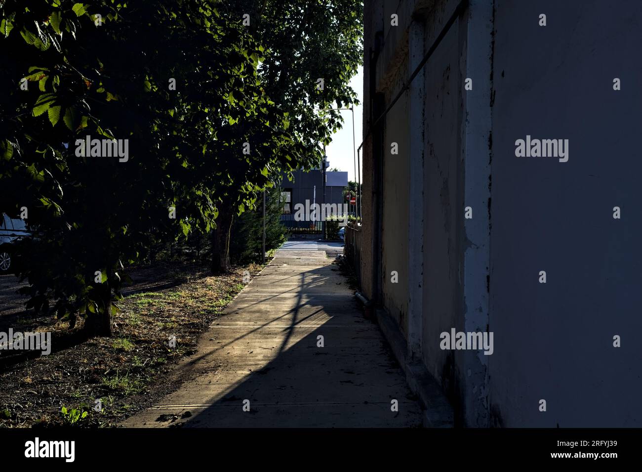 Gravel path in a park next to a building that leads to a pedestrian ...