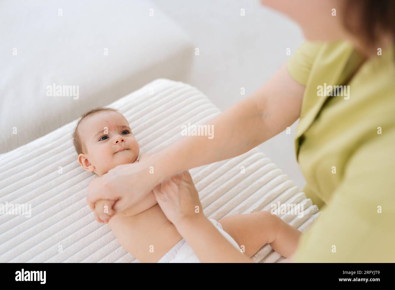 Back top view from shoulder of unrecognizable pediatric masseur with ...