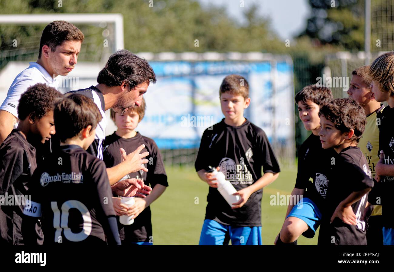 Trainer gave direction to young kids children teenage boys - playing ...