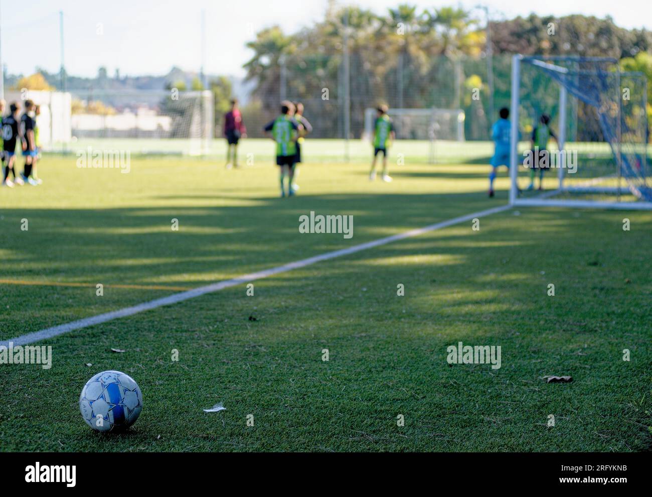 Young kids children teenage boys playing football soccer game sports in ...