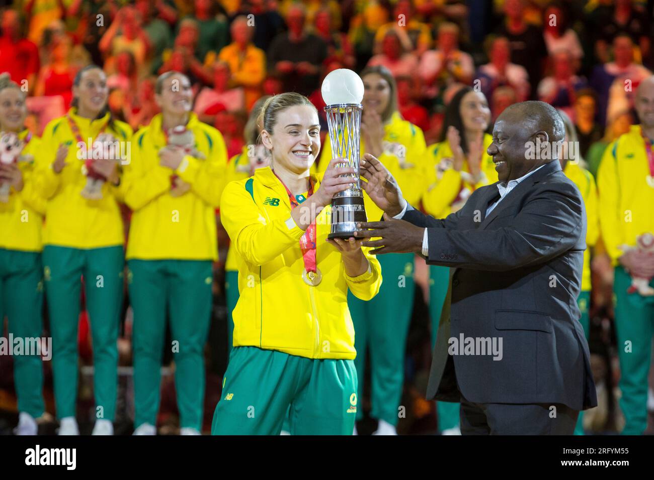 Liz Watson, captain of Australia, receives the Netball World Cup trophy from South African ...