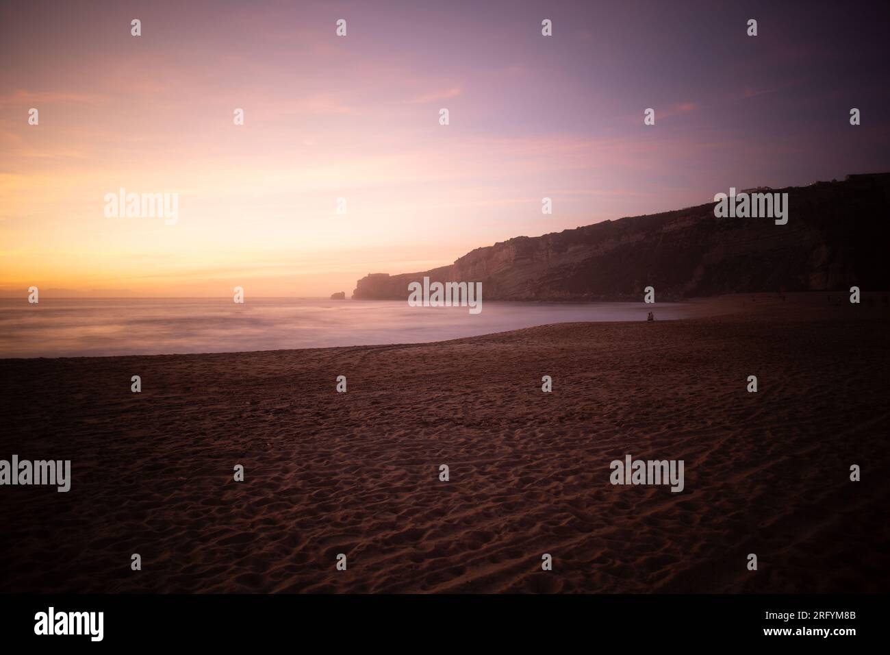 Nazaré's mesmerizing promontory: Sunset's golden embrace paints the ...