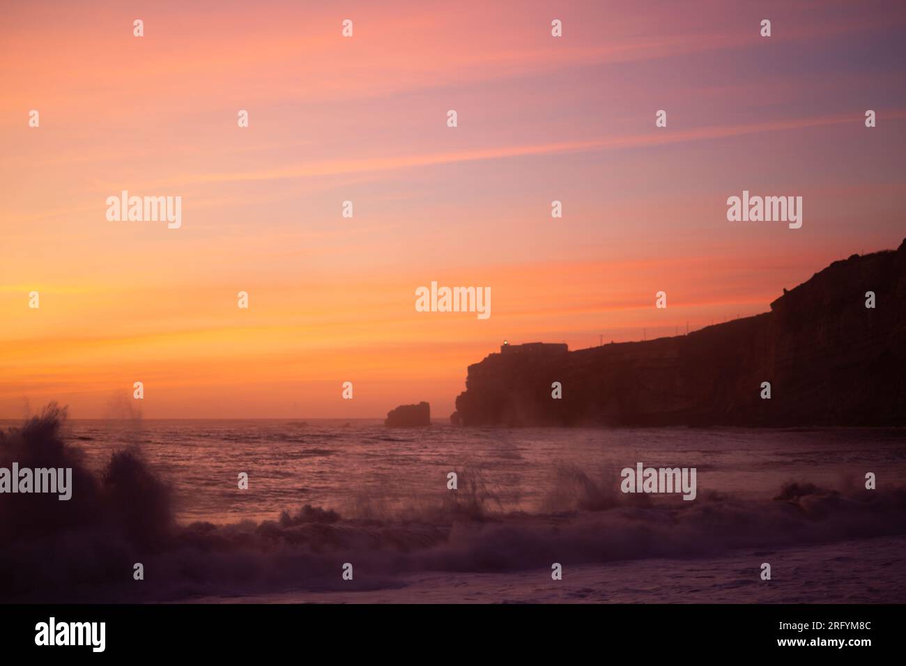 Nazaré's mesmerizing promontory: Sunset's golden embrace paints the ...