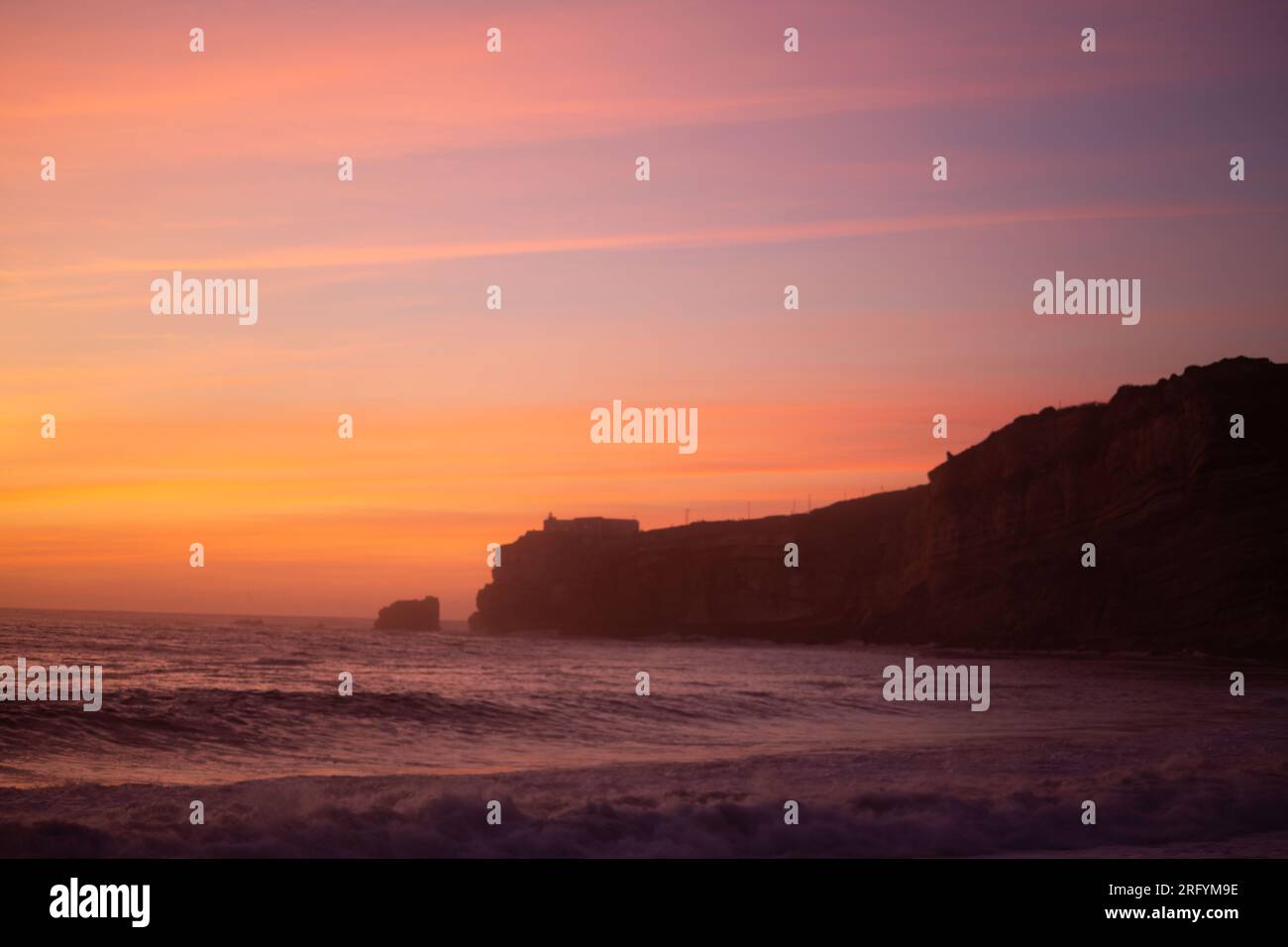 Nazaré's mesmerizing promontory: Sunset's golden embrace paints the ...