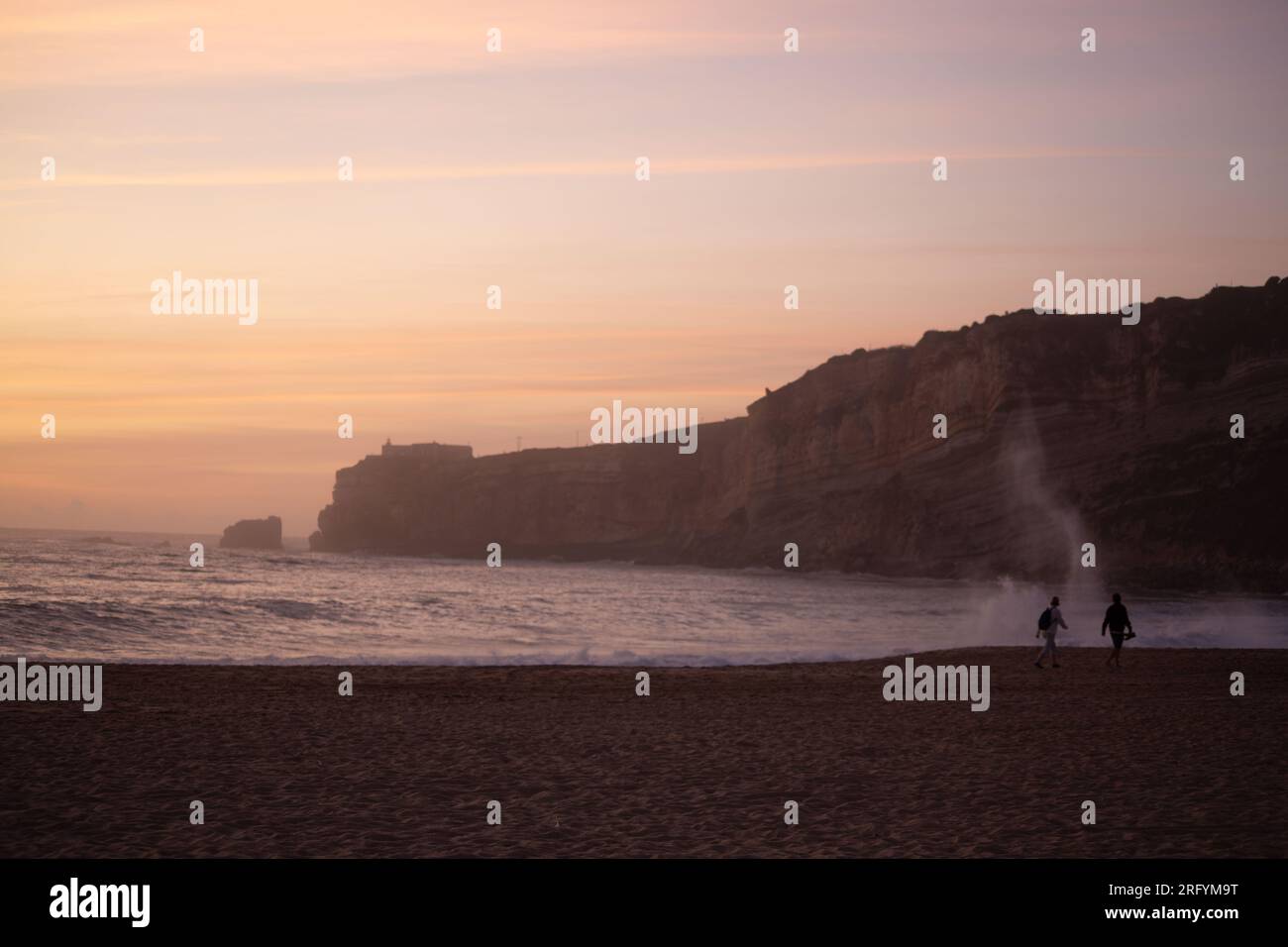 Nazaré's mesmerizing promontory: Sunset's golden embrace paints the ...